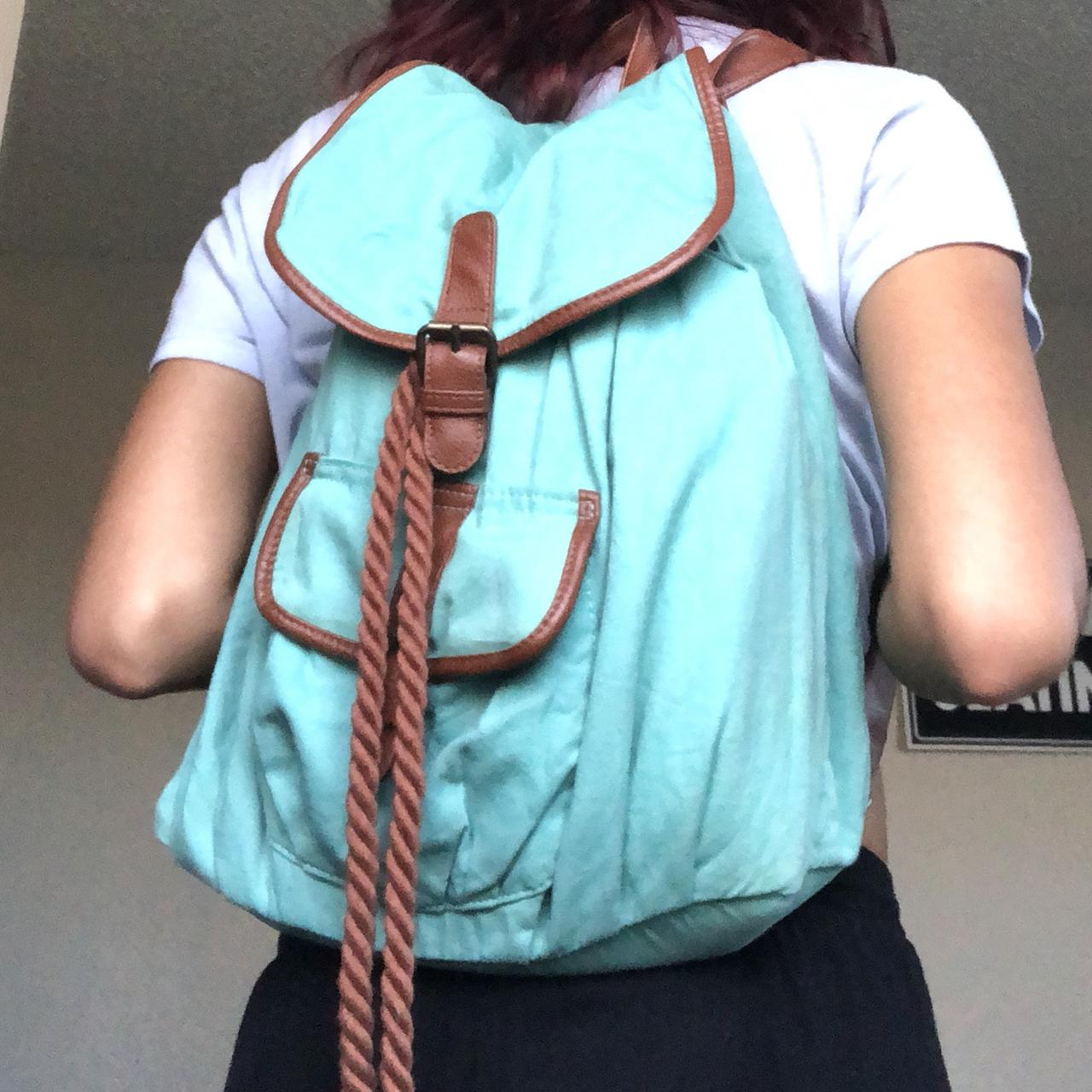 very cute teal colored backpack! it has drawstrings... - Depop