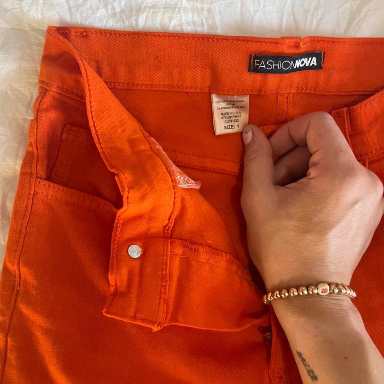 Fashion Nova flared bright orange jeans Size... - Depop