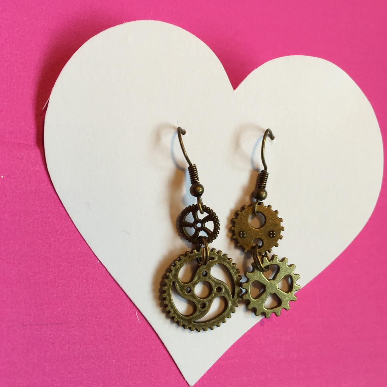 Brass coloured asymmetric cog earrings. Approx 2cm... - Depop