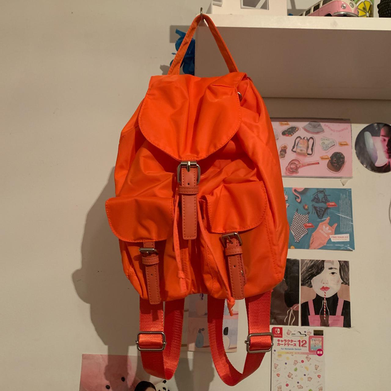Orange mini backpack from Urban Outfitters with... - Depop