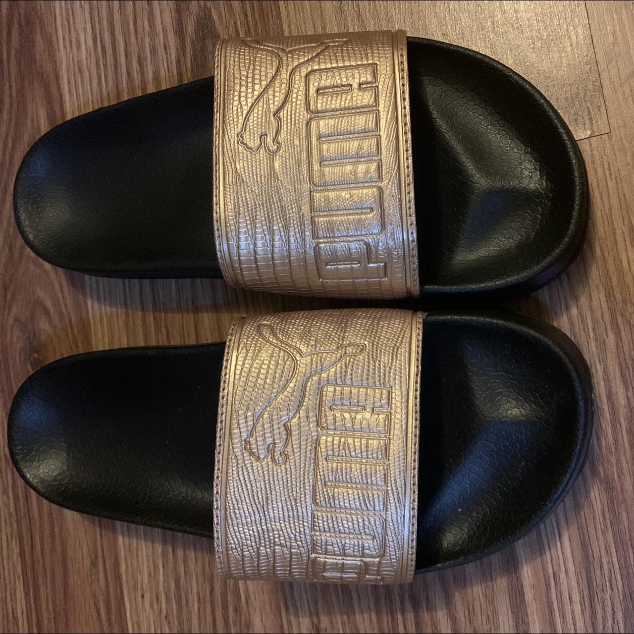 gold and black puma slides - Depop