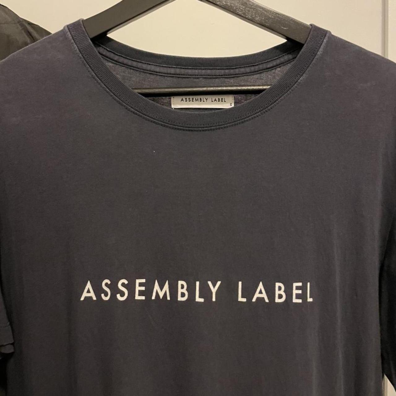 ASSEMBLY LABEL TEE navy tee with logo on front... - Depop