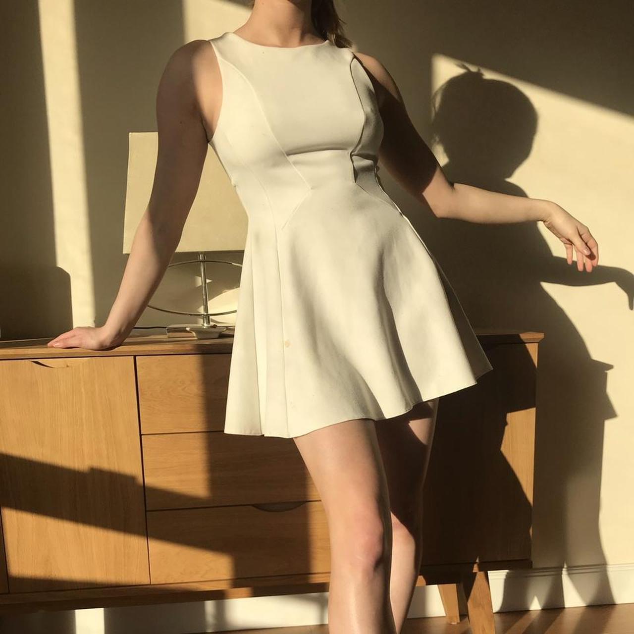 Selling this super cute white mini dress! Some marks... - Depop