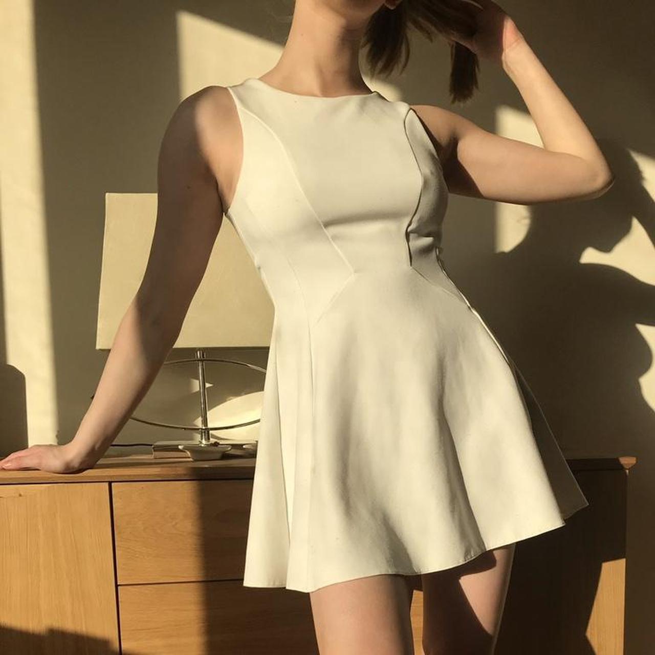 Selling this super cute white mini dress! Some marks... - Depop