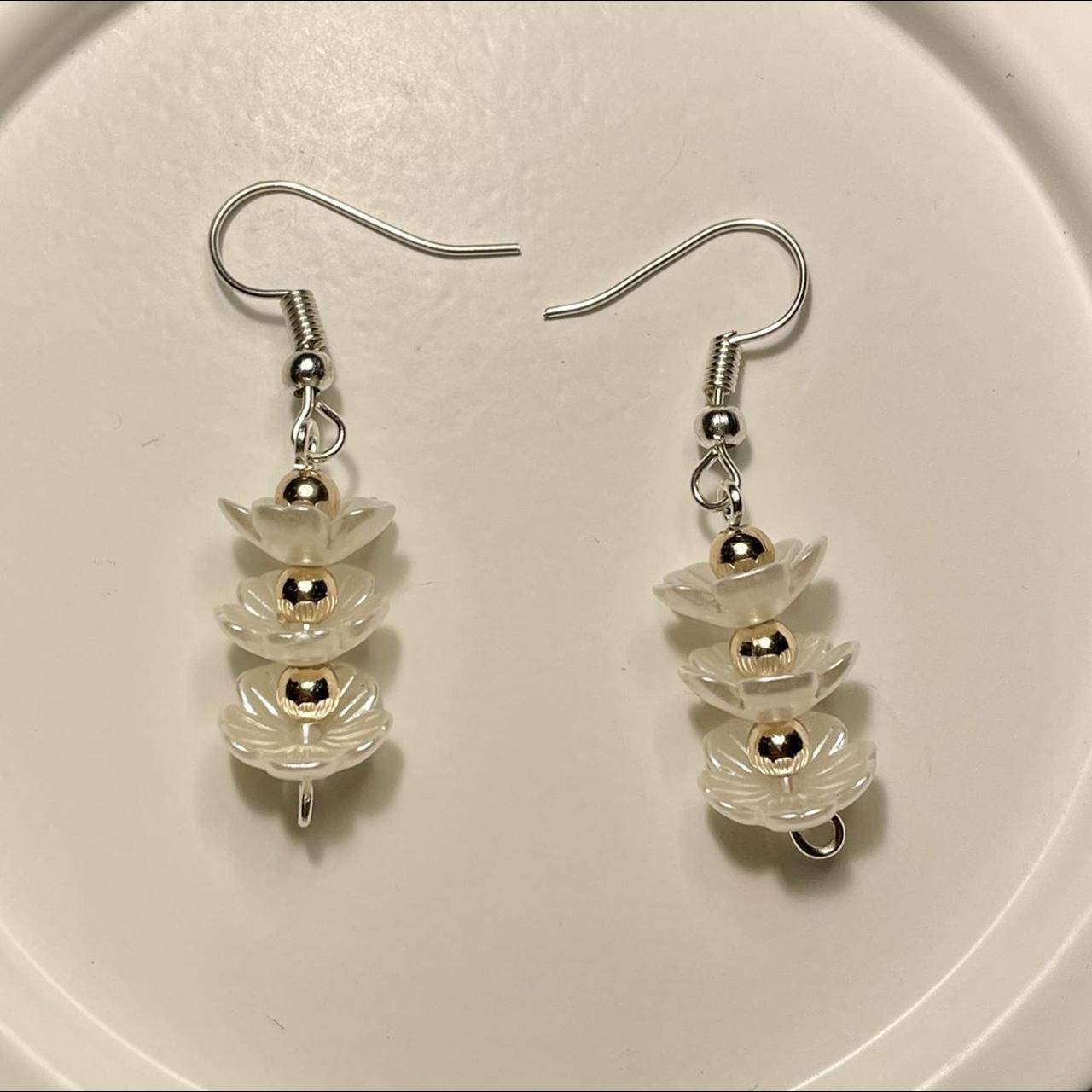 pearly finish flower token beads with gold ball... - Depop