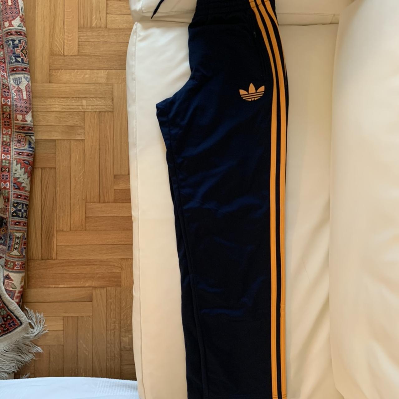 Tuta pantalone Adidas blu notte e bande arancioni.... | Depop