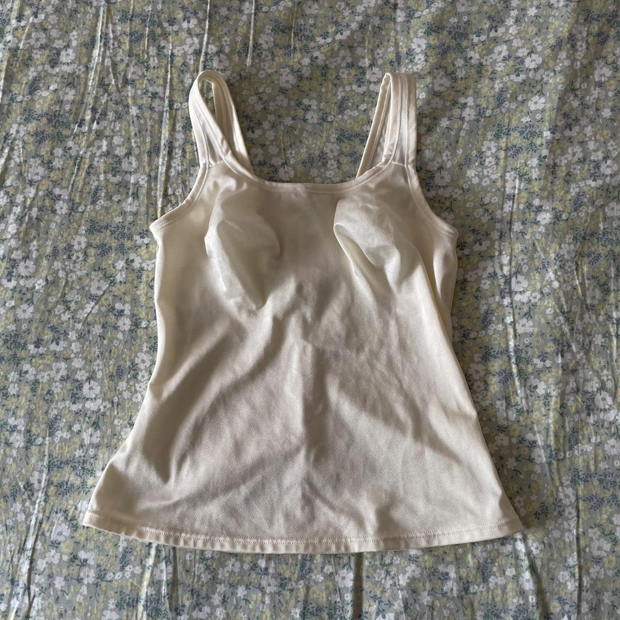cream tank top a spandex material that’s supposed... - Depop