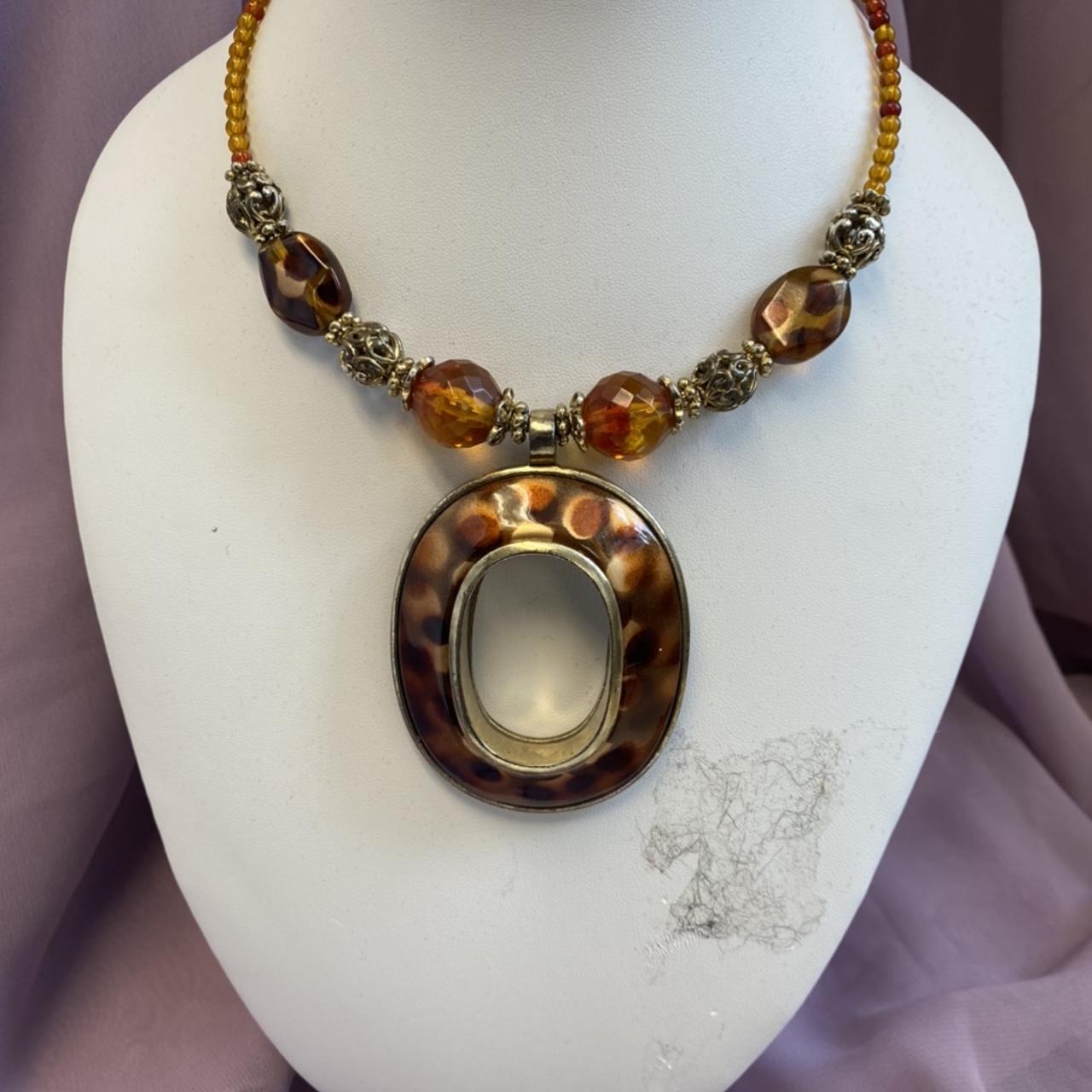Animal print resin Pendant necklace with amber... - Depop