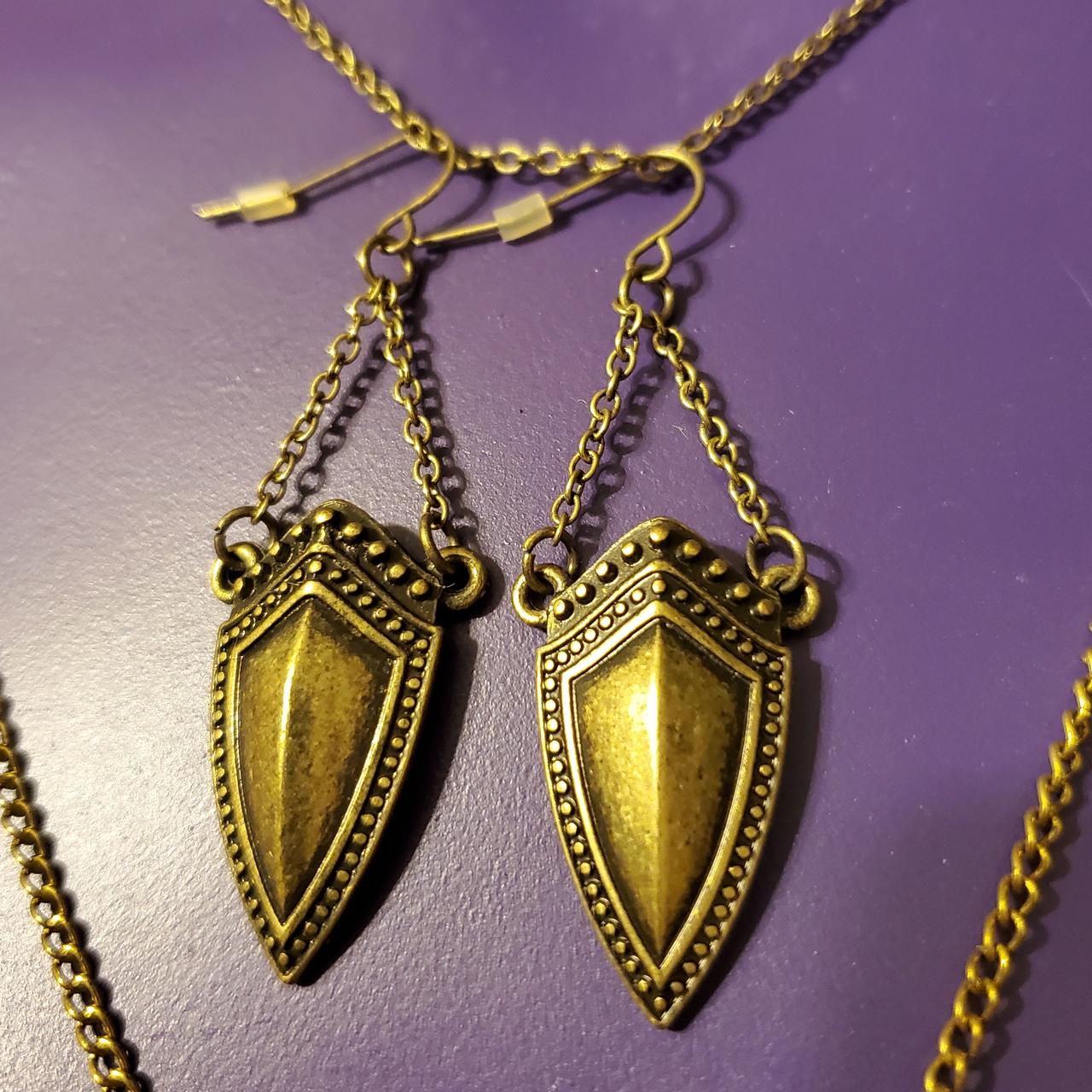 2 necklaces and earrings set. 1 shield necklace and... - Depop