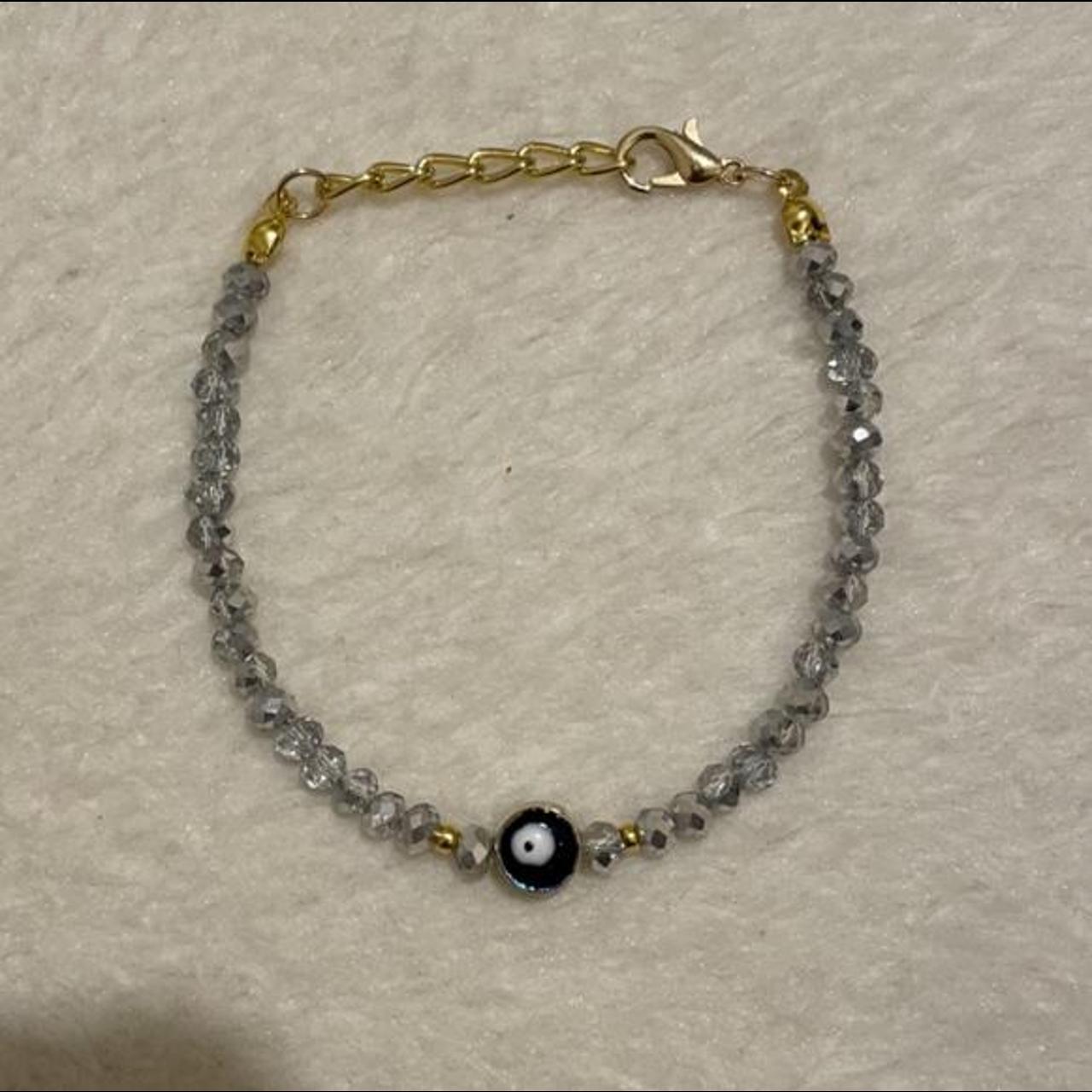 Grey beaded evil eye bracelet. Selling for £4... - Depop