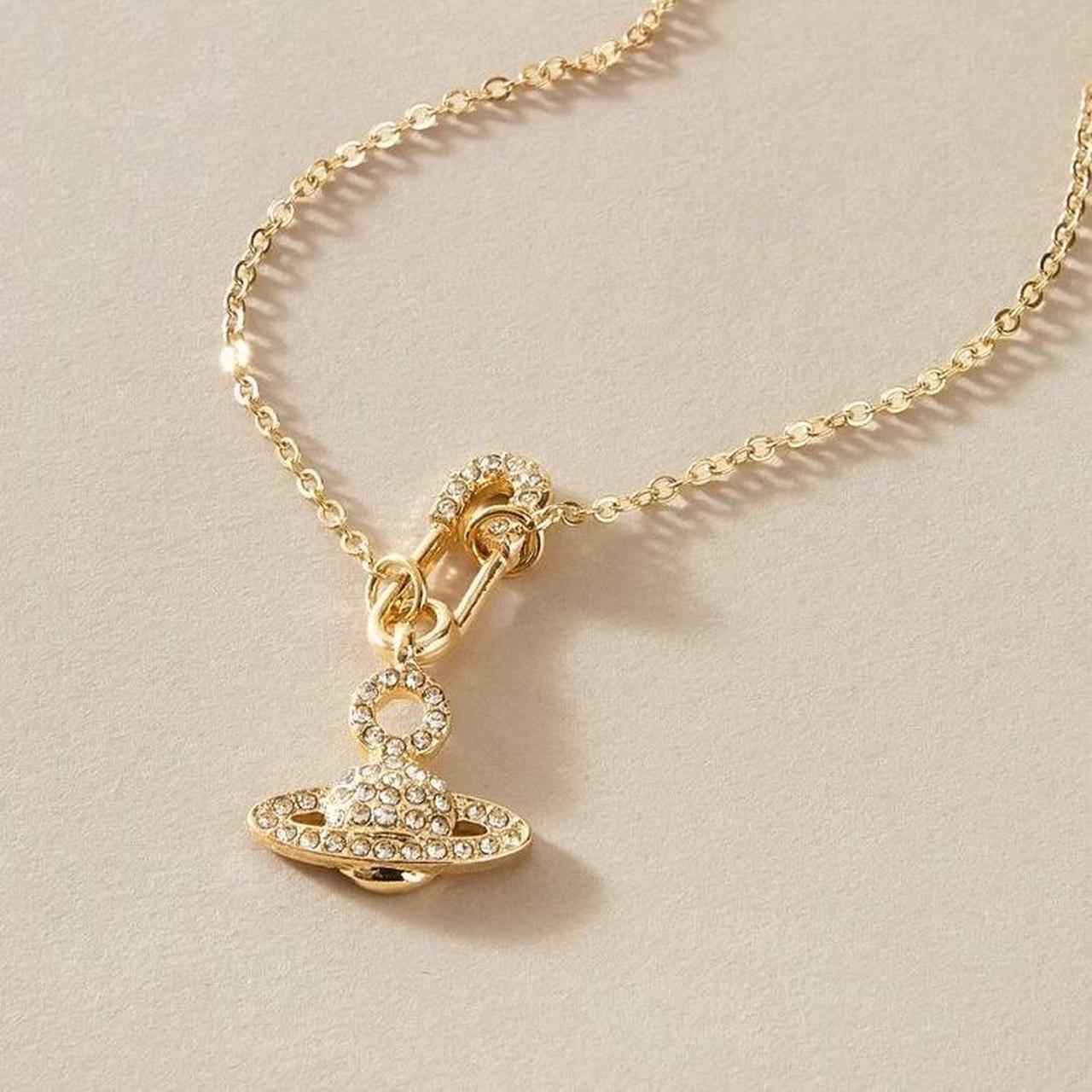 GOLD SATURN NECKLACE description: super cute gold... - Depop