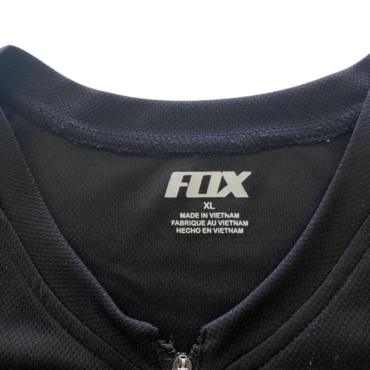 This is a black Fix Racing zip up. It is mainly... - Depop