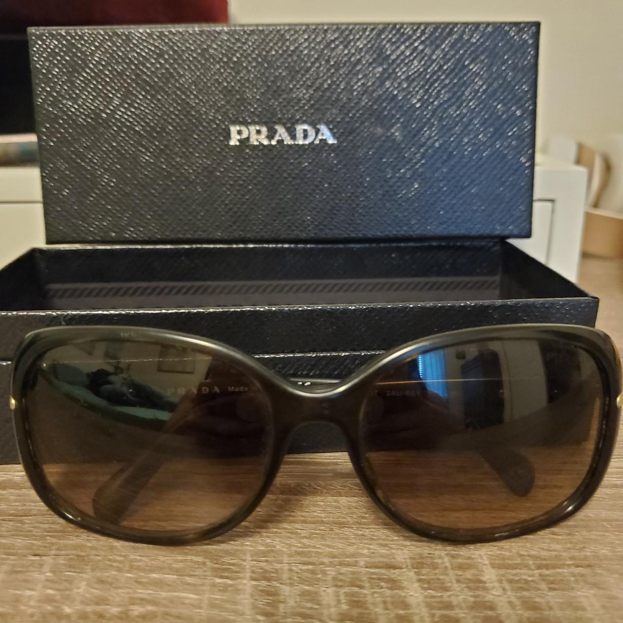 Black prada sunglasses with gold trim on the sides.... - Depop