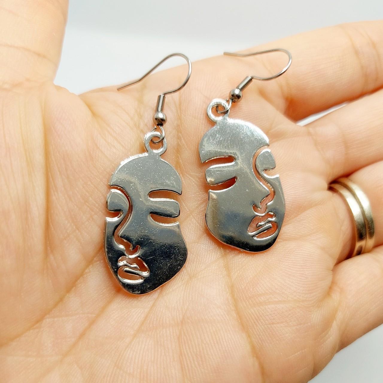 Silver plated face charms on stainless steel earring... - Depop