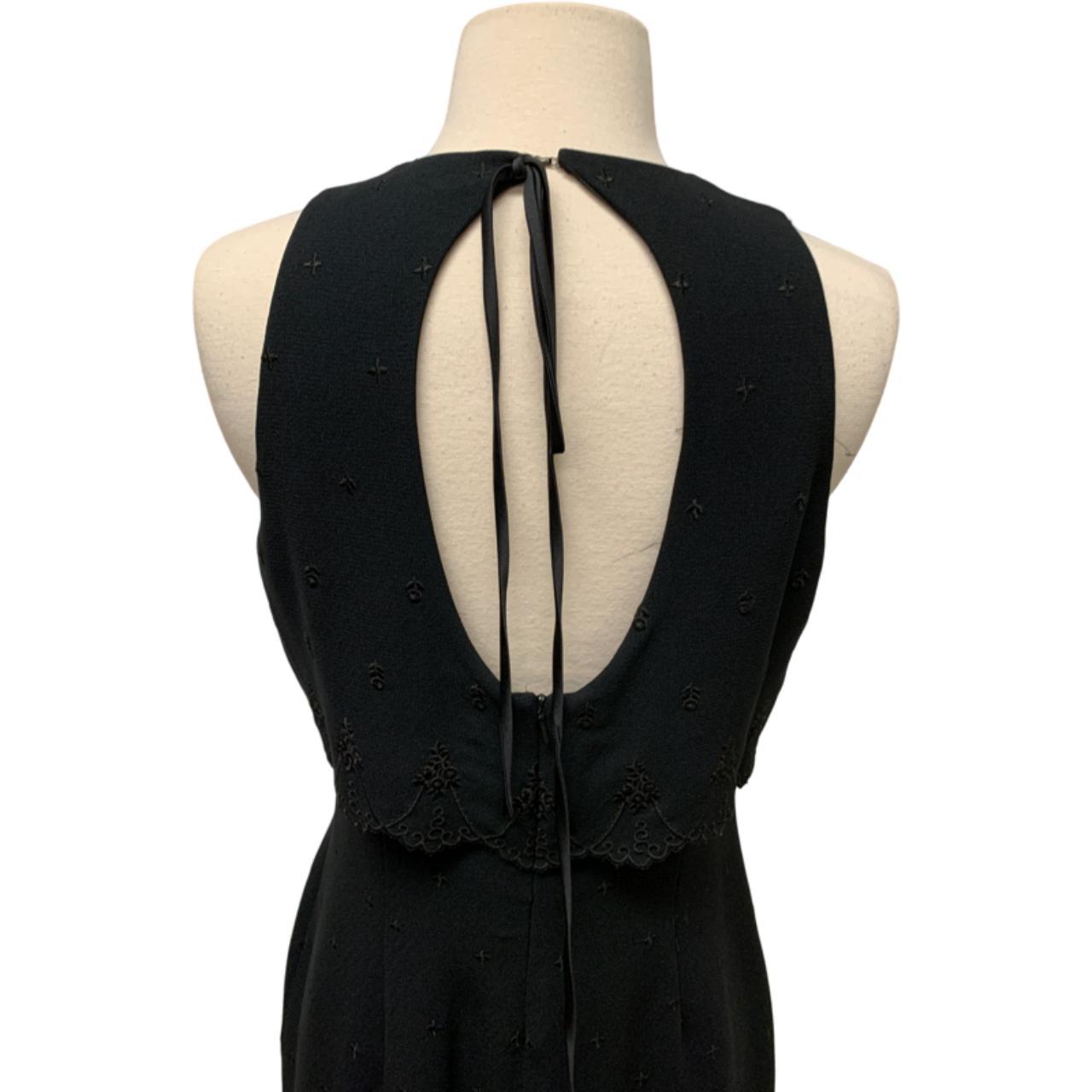 This black mini dress features an overlay of fabric... - Depop