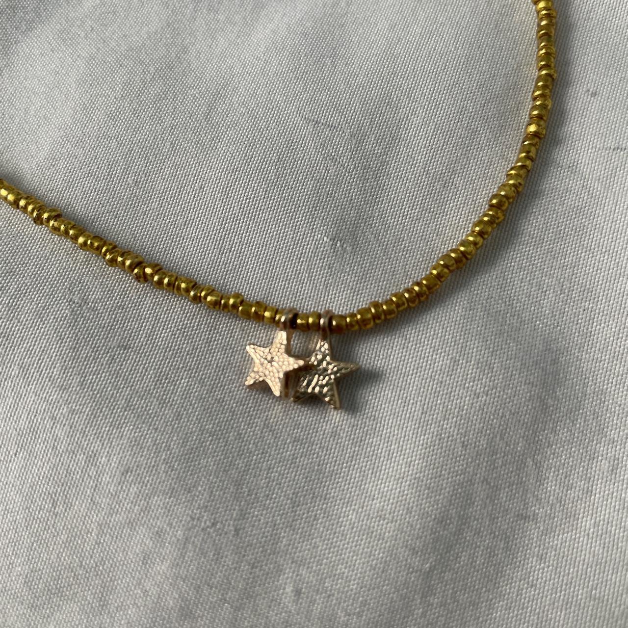Super cute, gold necklace with 2 sparkly star... - Depop