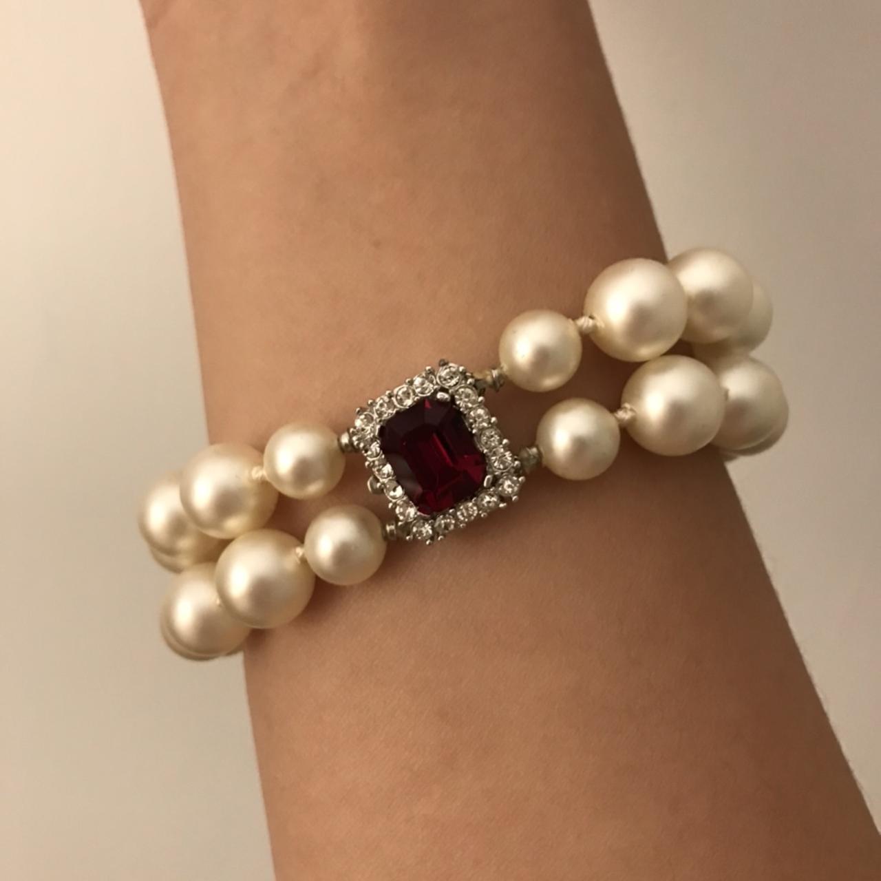 This classic faux pearl bracelet exudes elegance to... - Depop