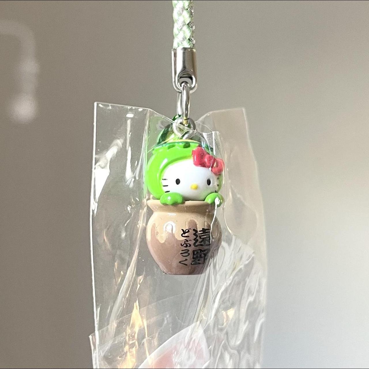 hello kitty wearing a green tono kappa costume... - Depop