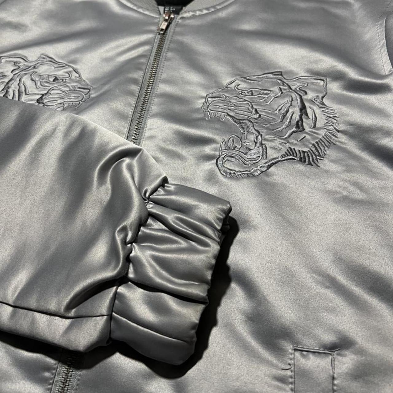 Silver shiny varsity jacket, world tour in back 2... - Depop