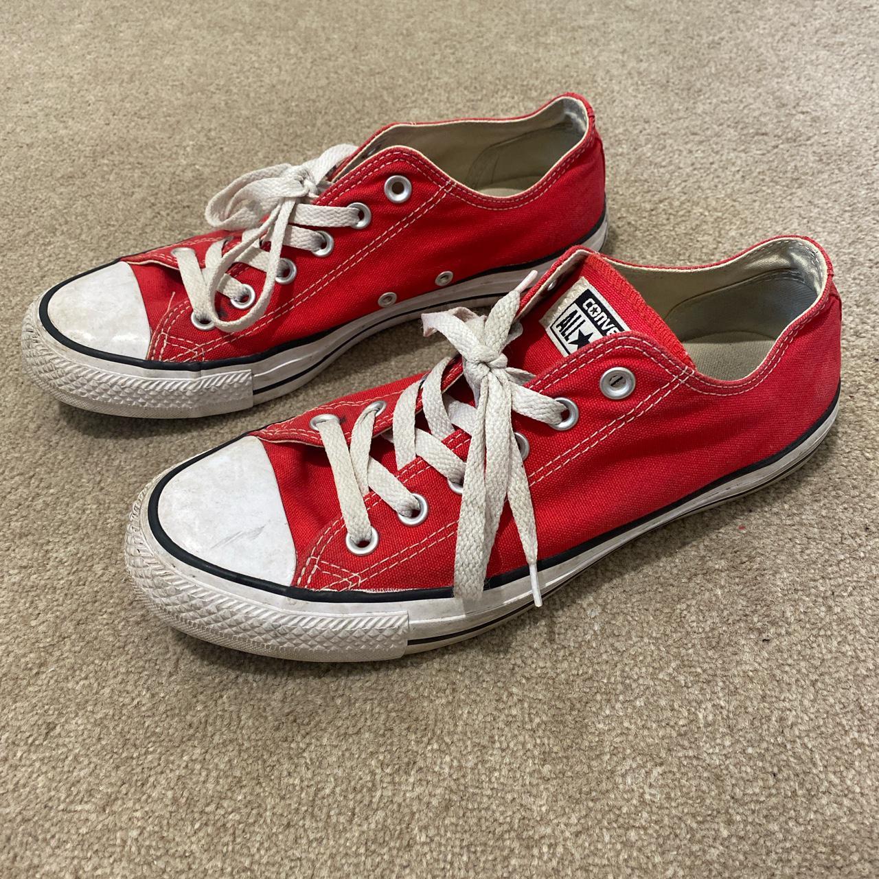 Red converse low tops. They are worn but there is... - Depop