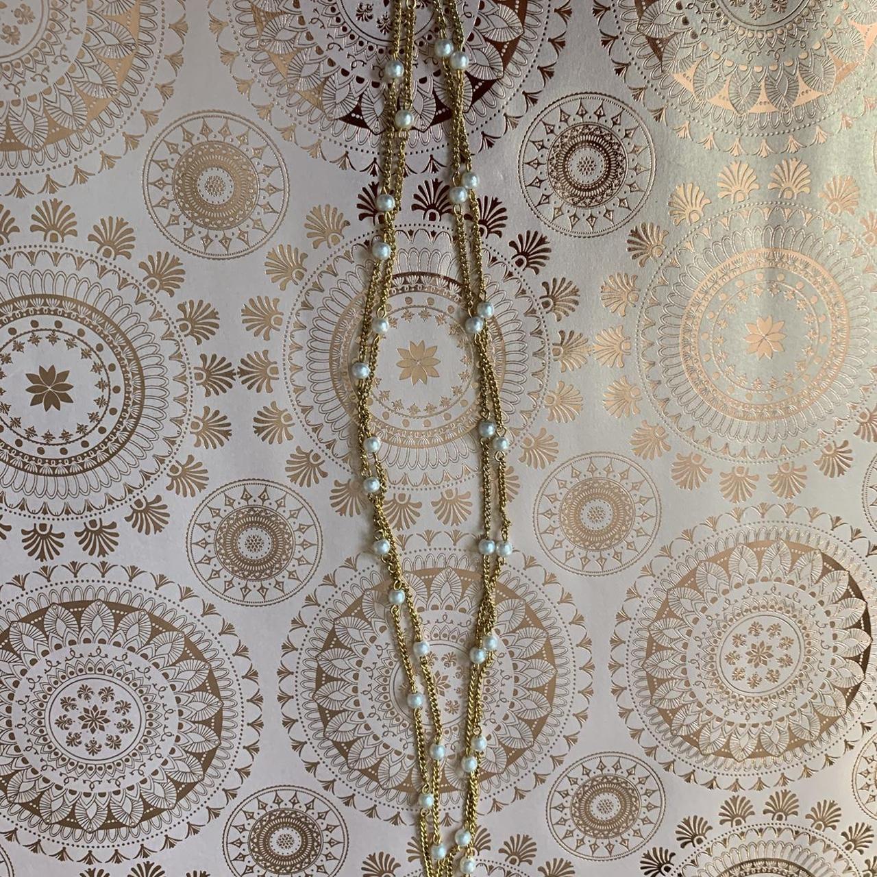 Long string of pearl like beads on gold chain. - Depop