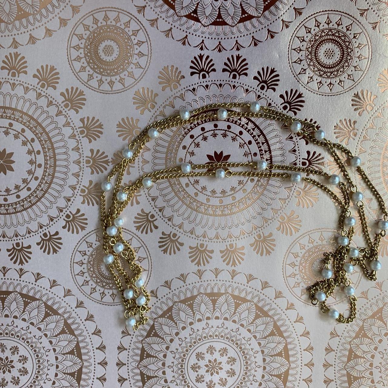 Long string of pearl like beads on gold chain. - Depop