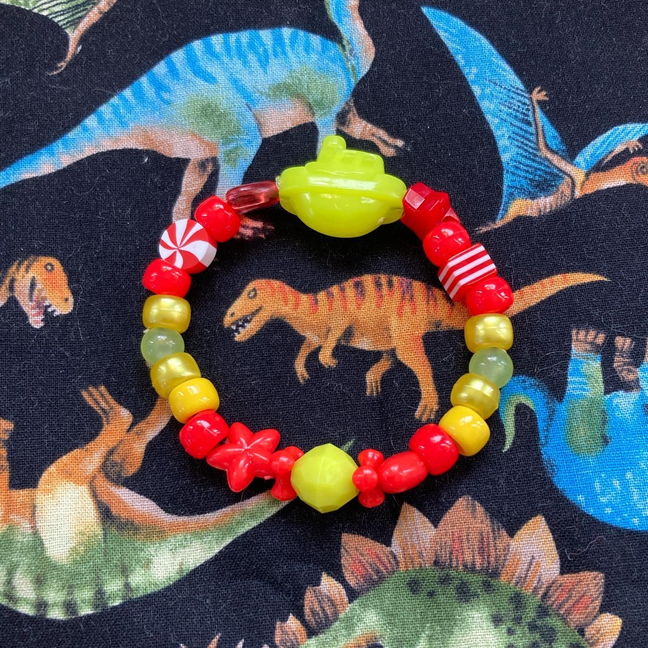 childish and fun kandi single with big neon boat... - Depop