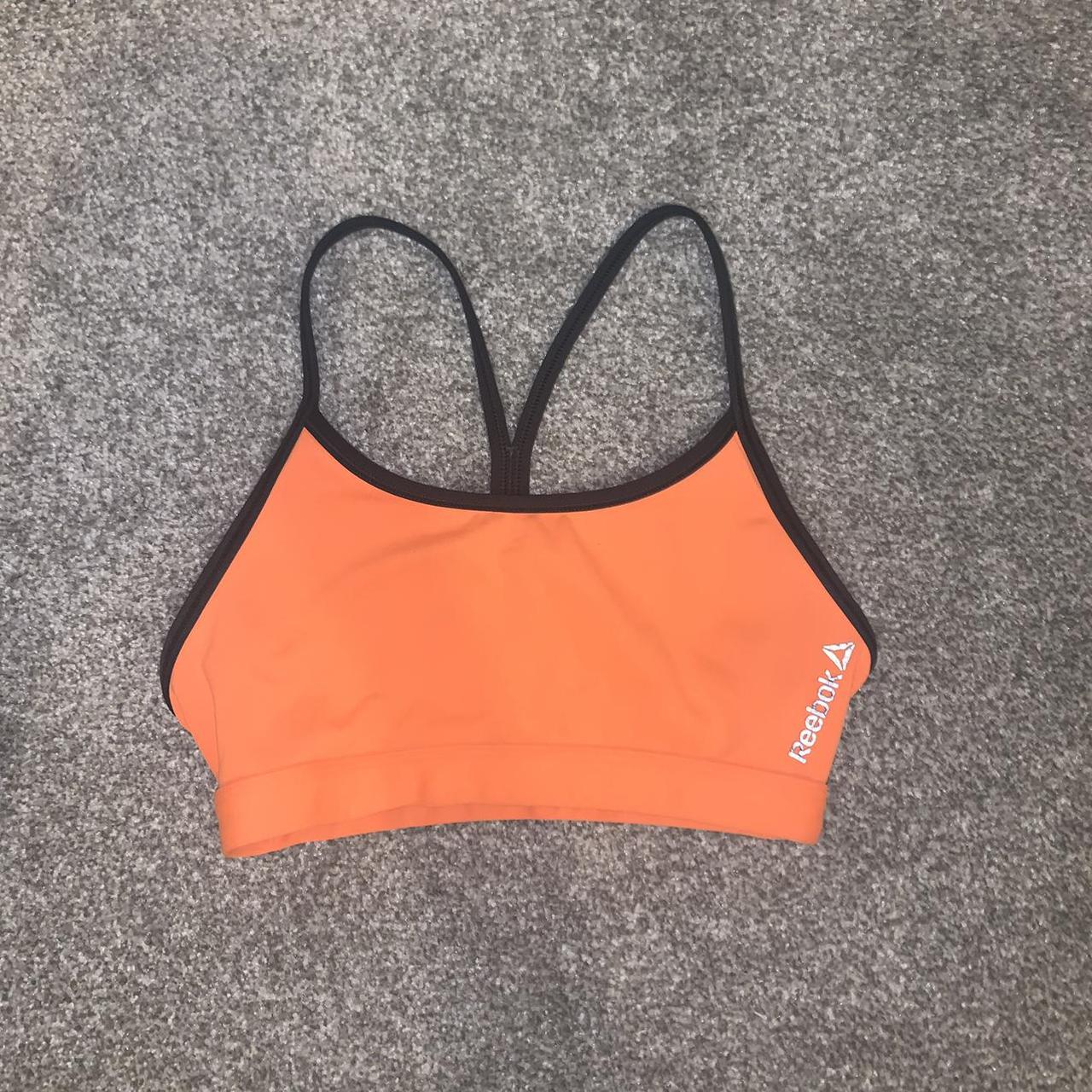 Bright fluorescent orange sports bra from Reebok.... - Depop