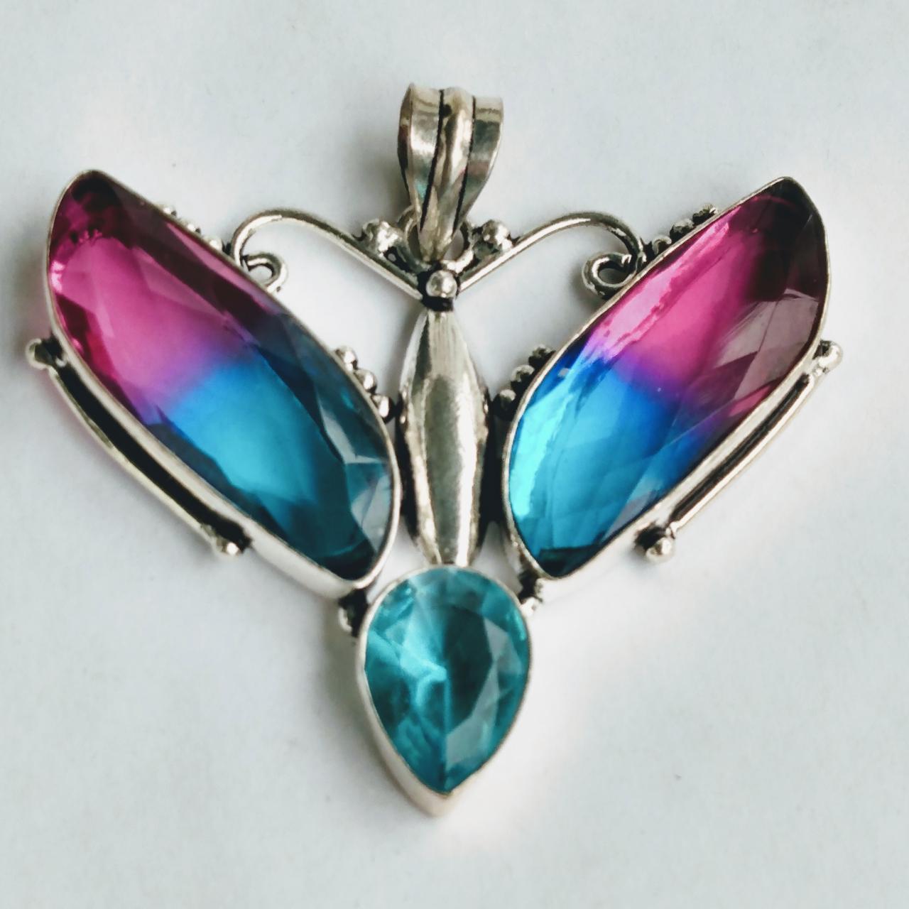 This is a blue and pink quartz pendant set in... - Depop