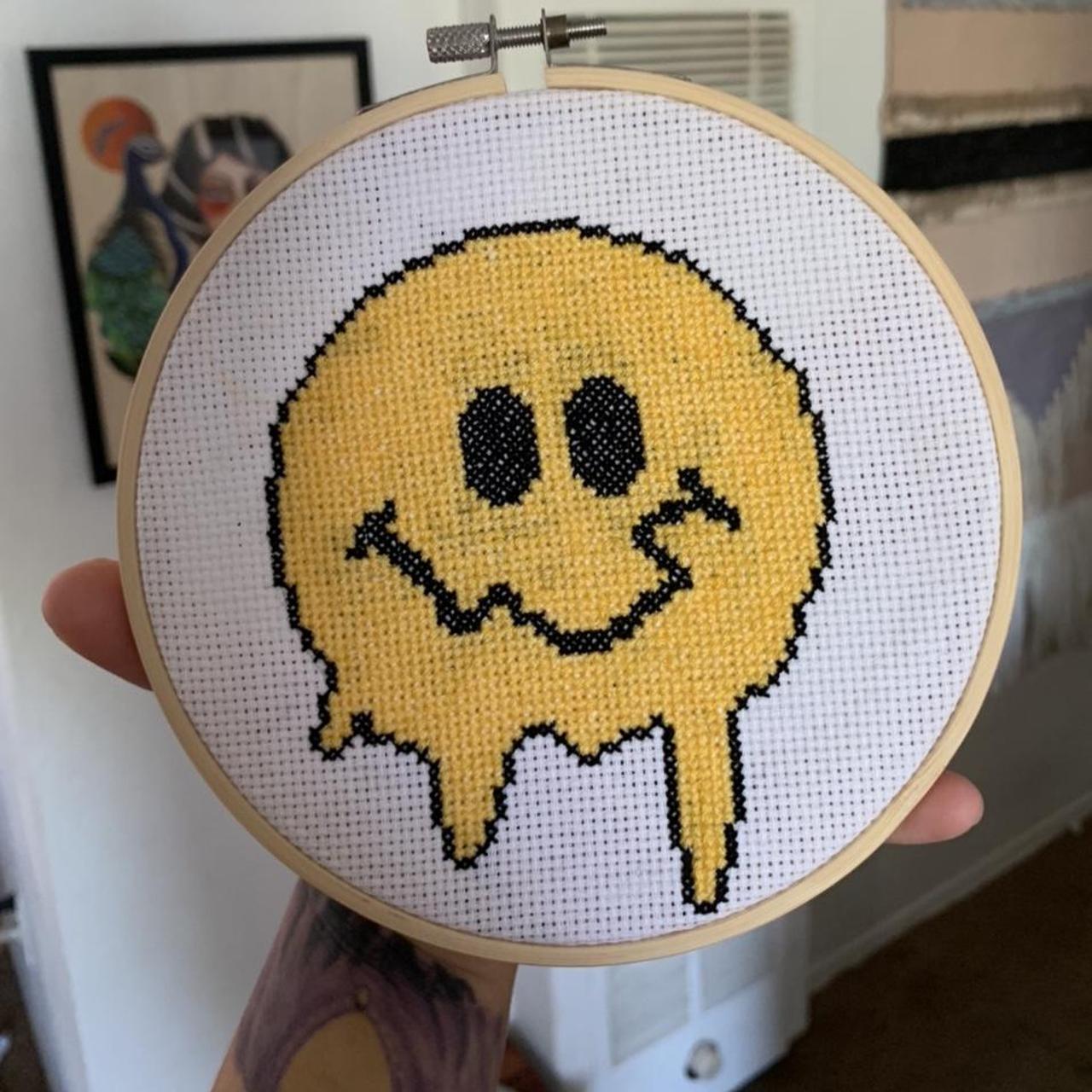 6 inch cross stitch of a melted smiley face. Framed... - Depop