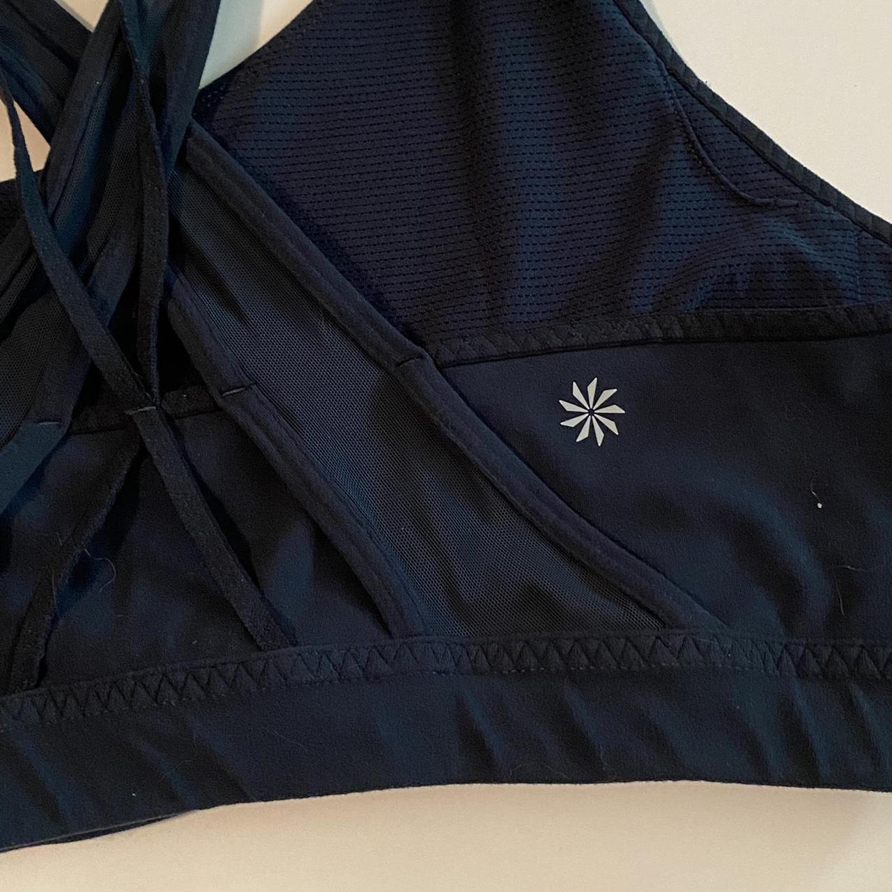 Athleta navy sports bra, size XL. Straps cross in... - Depop