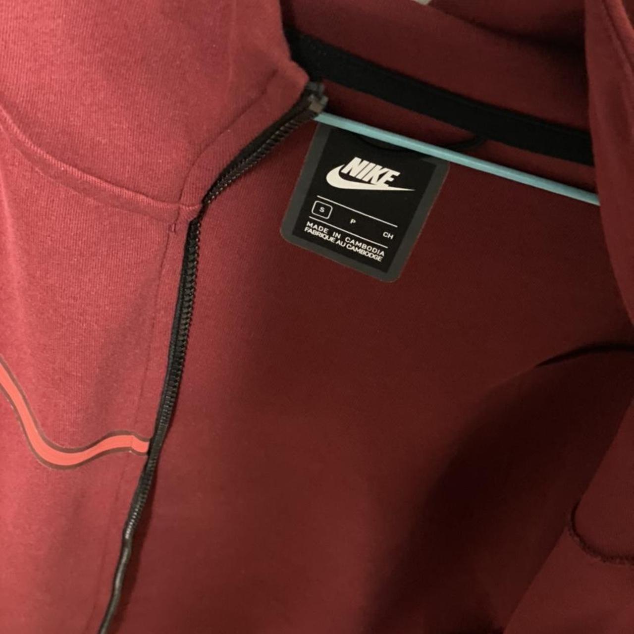 Dark red tech fleece jacket. slightly torn, not... - Depop