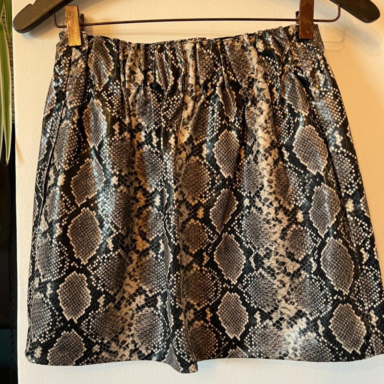 Sara snake print mini skirt with button front detail... - Depop
