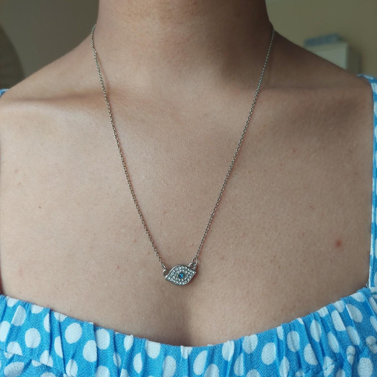 Evil eye silver necklace with blue stone detailing... - Depop