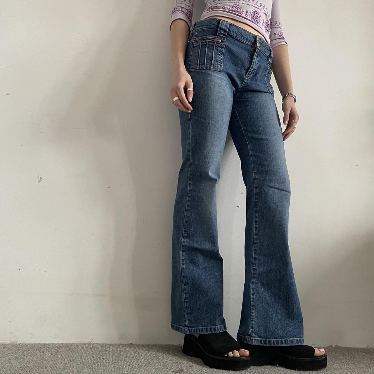 Flared denim jeans. Blue low rise flared jeans from... - Depop