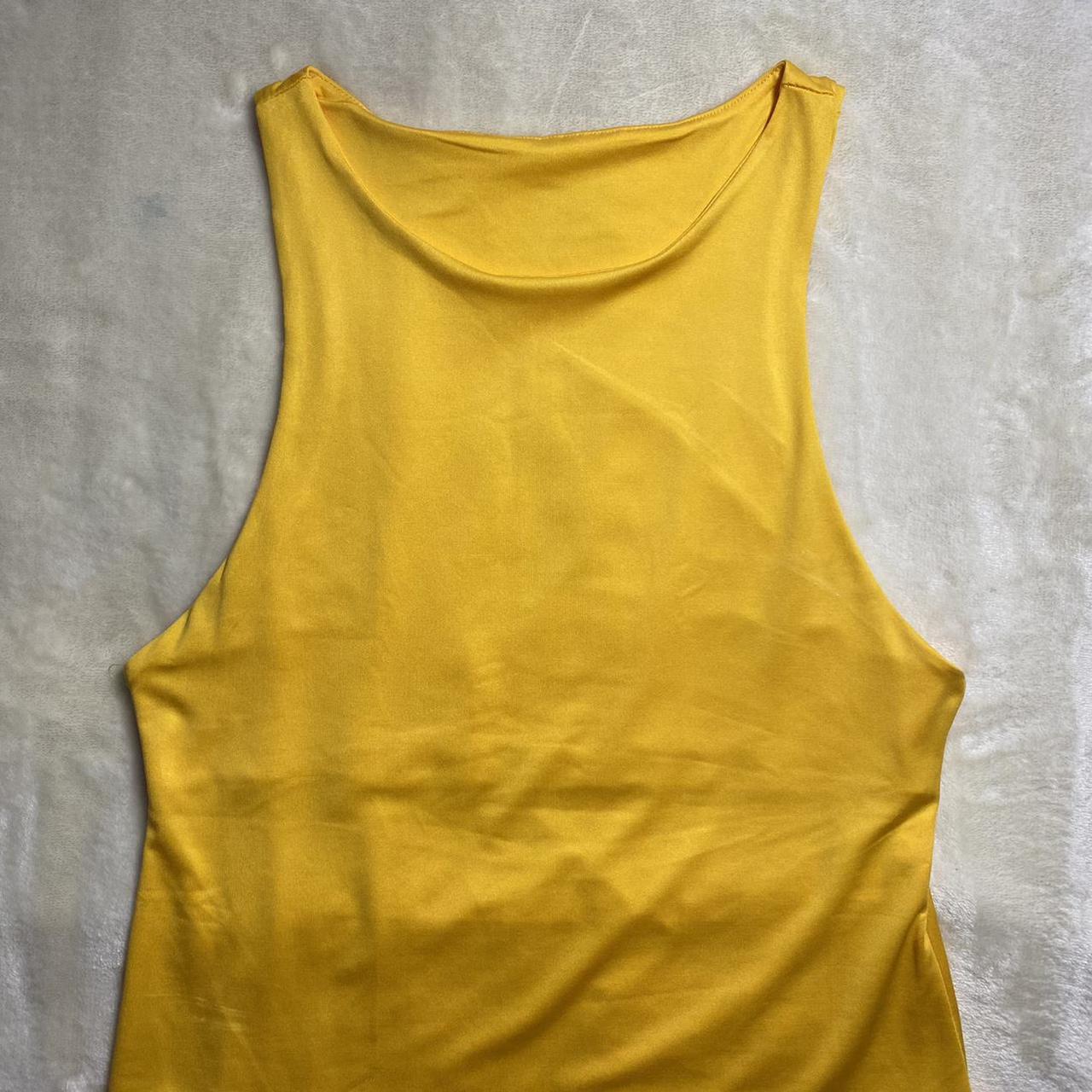 Bright yellow racer back bodysuit. Has lining in... - Depop