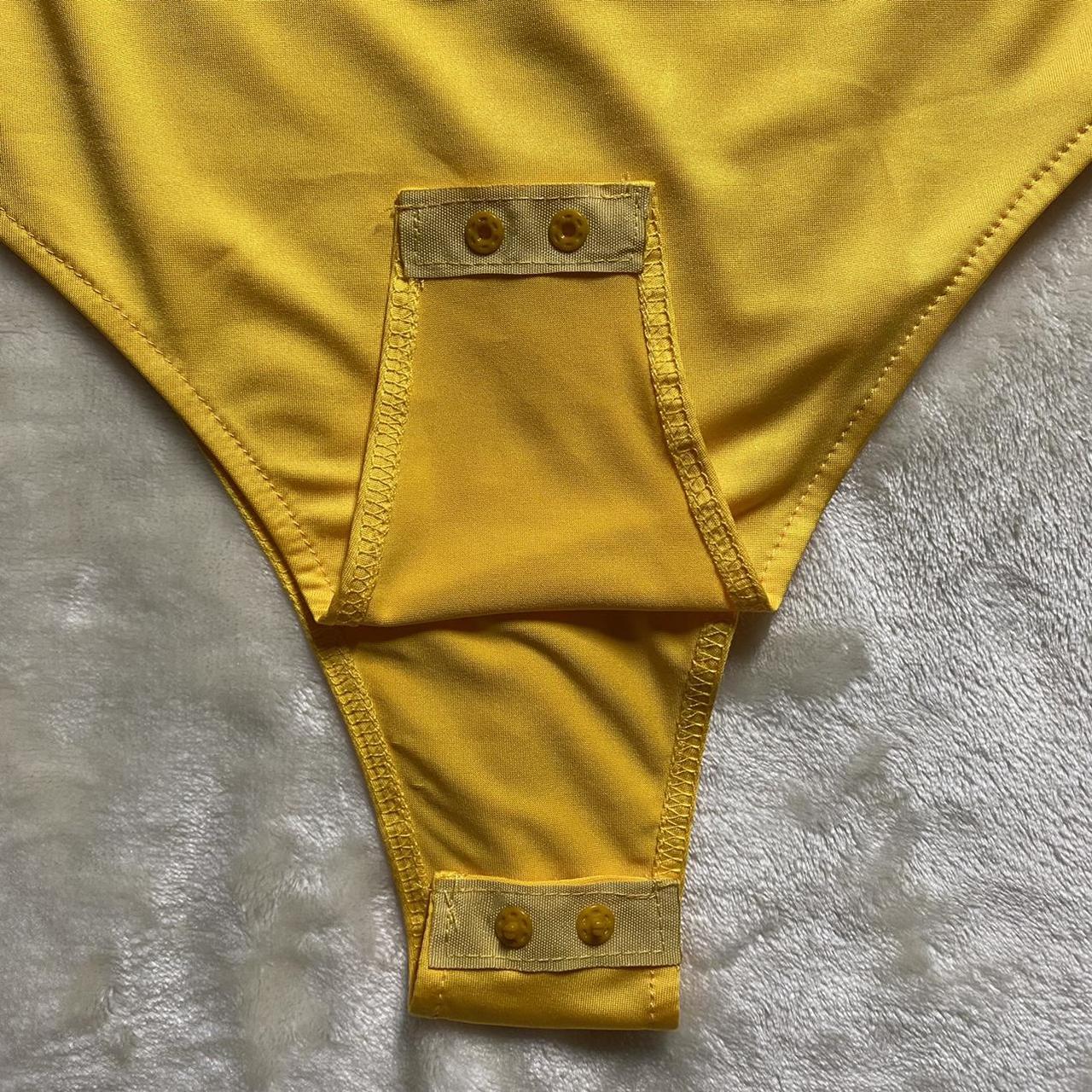 Bright yellow racer back bodysuit. Has lining in... - Depop