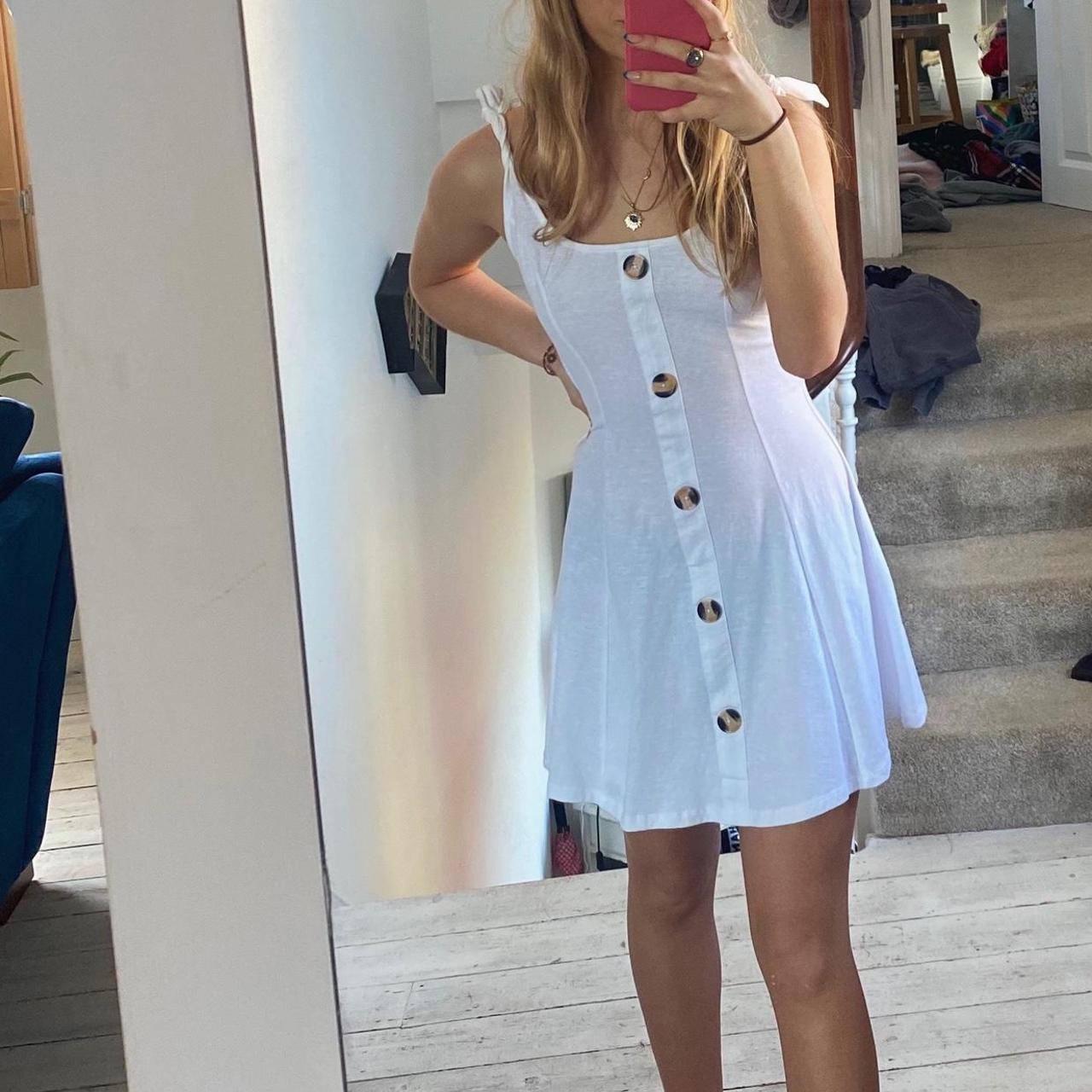Cute simple white mini dress with button details... - Depop