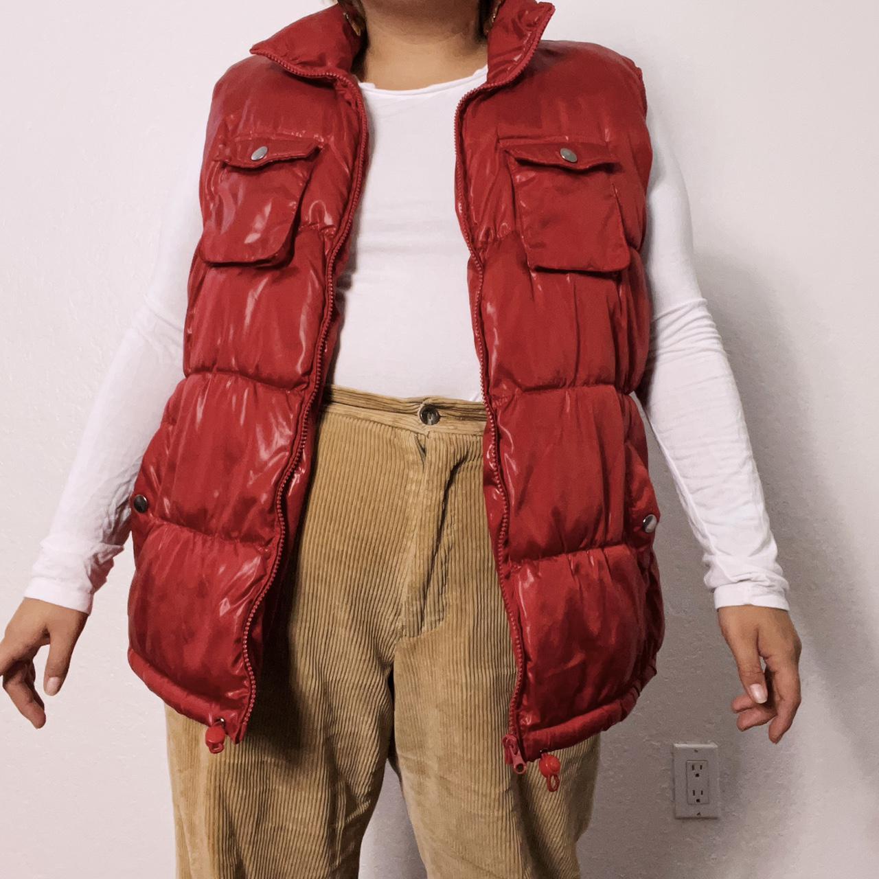 Red puffer vest shiny look to it with four pockets... - Depop