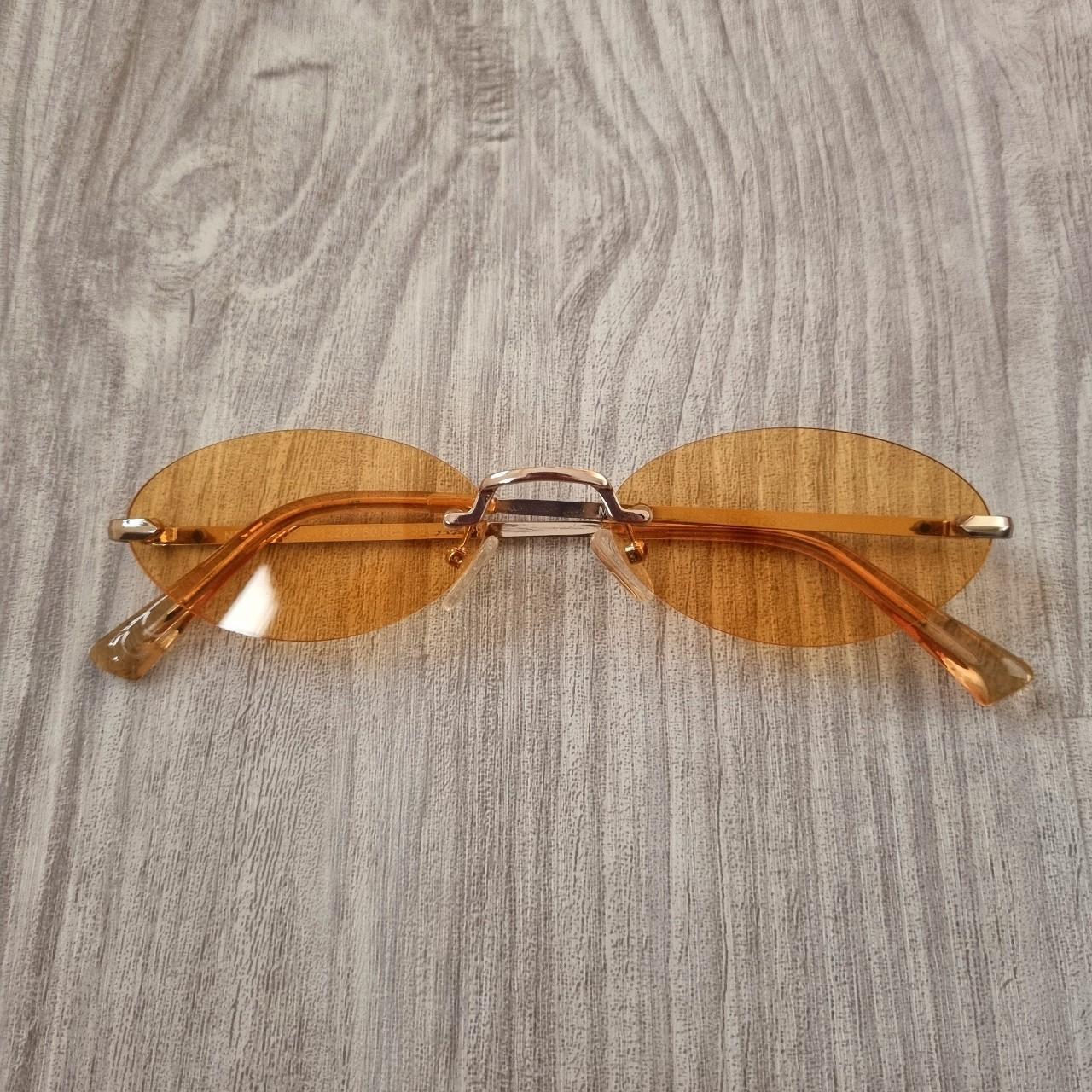 Yellow tinted, rimless oval, gold detailed... - Depop