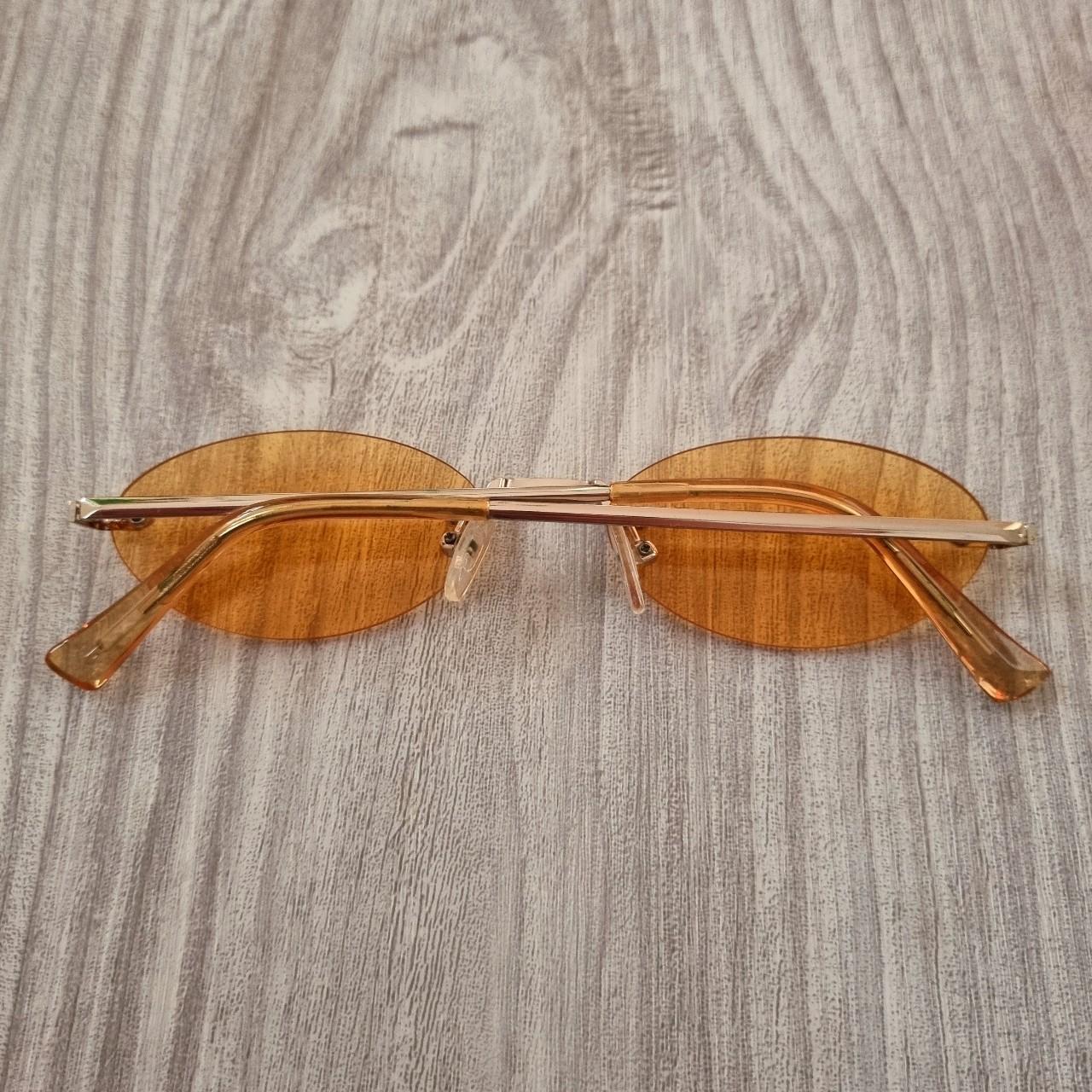 Yellow tinted, rimless oval, gold detailed... - Depop