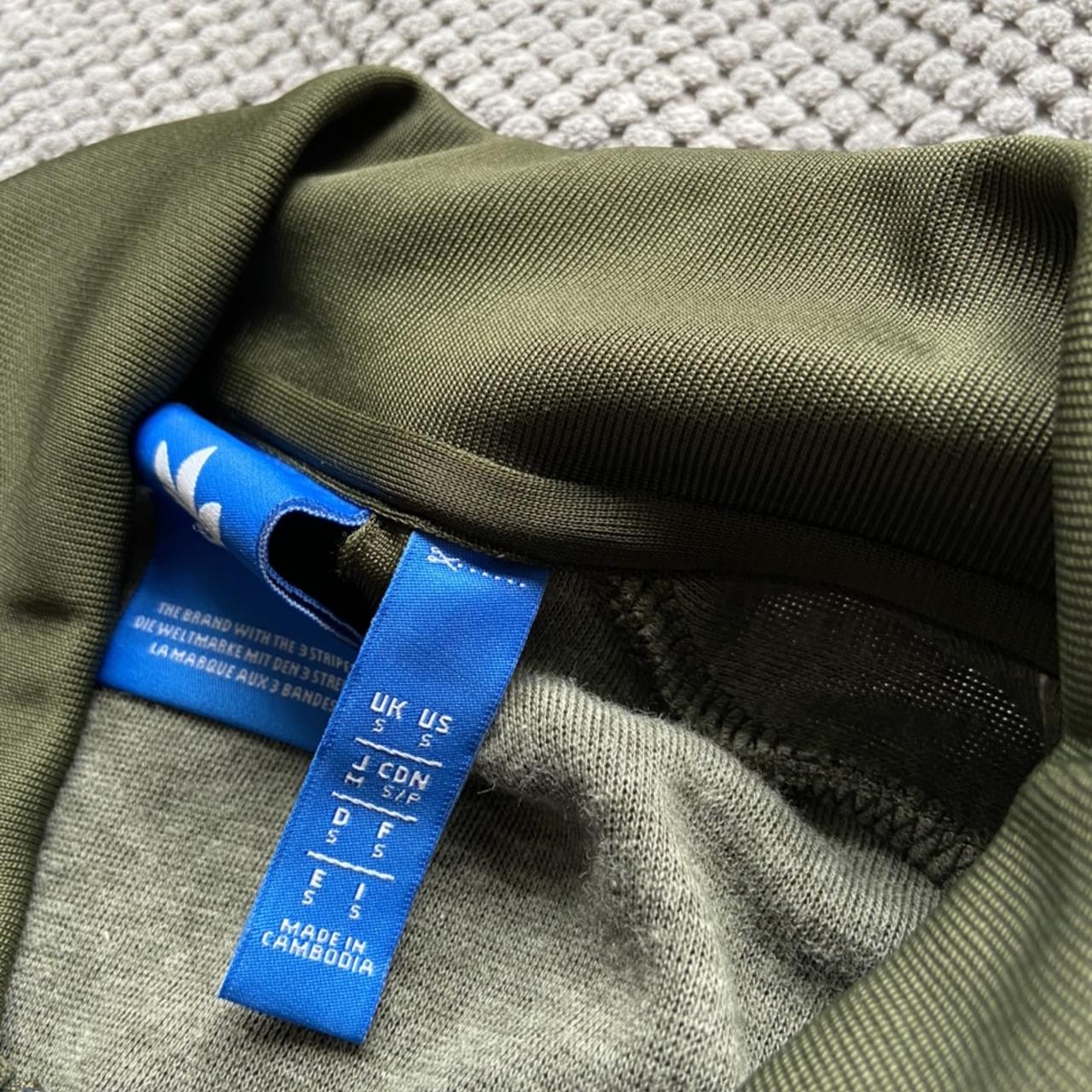 olive green adidas tracksuit top with white stripes... - Depop