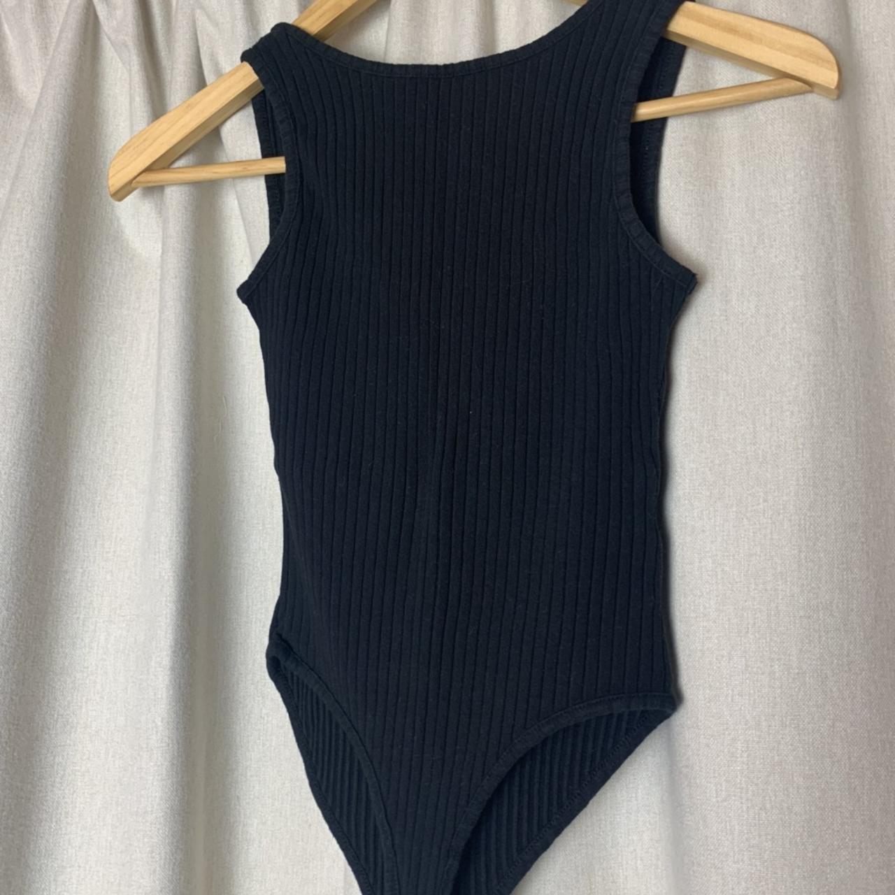 High neck black ribbed bodysuit with a low scoop... - Depop