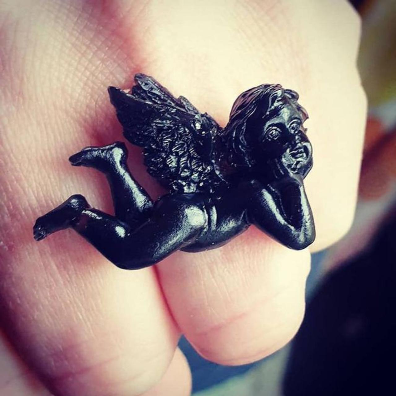 Black Lounging Cherub Ring. This resin cherub is a... - Depop