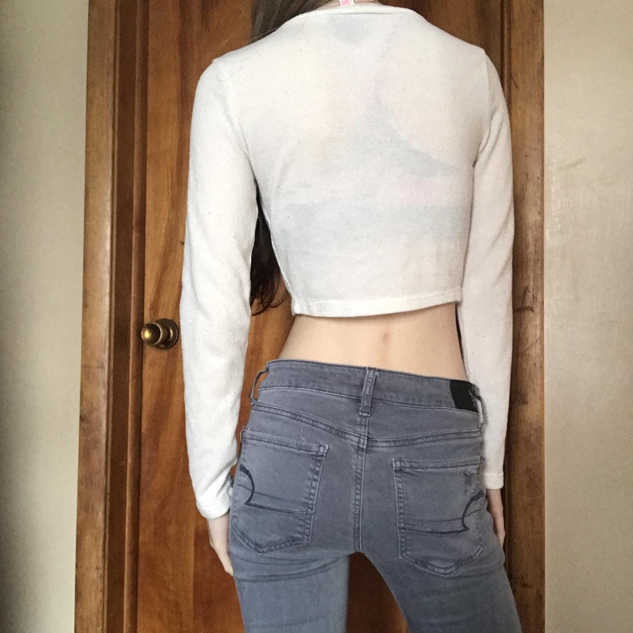 white cropped long sleeve sweater from delia*s with... - Depop