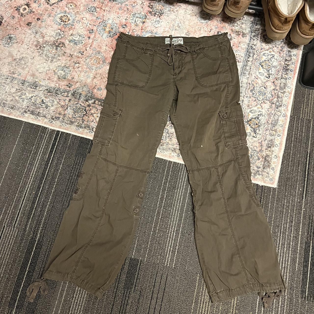 Low rise brown cargo pants. Two small bleach... - Depop