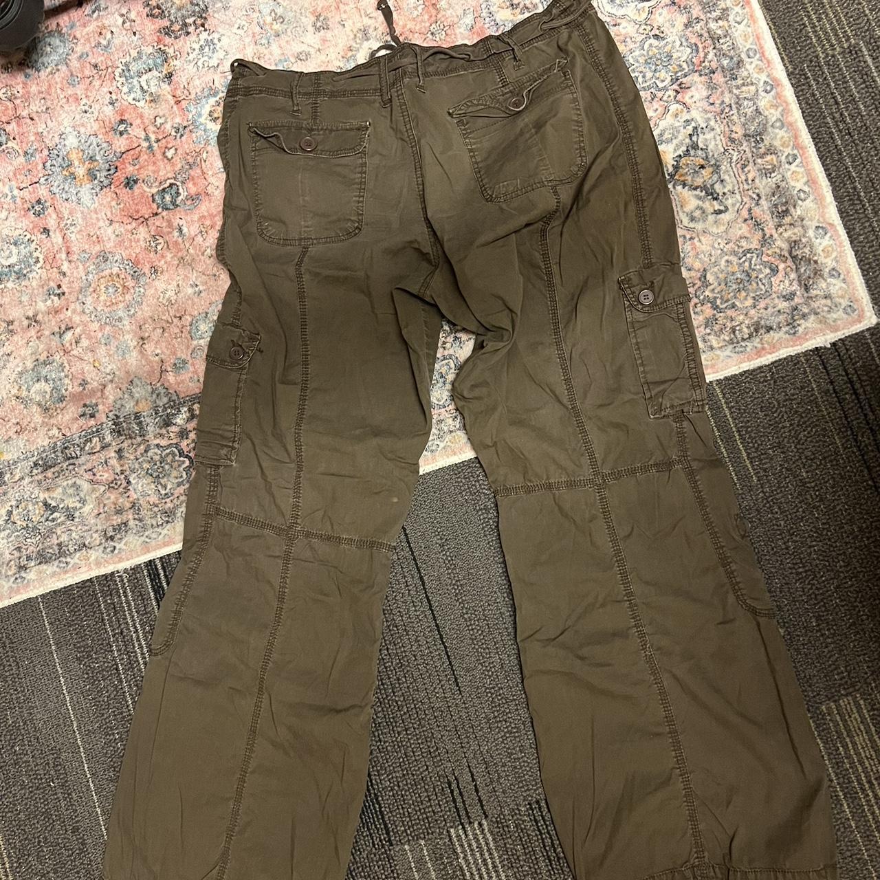 Low rise brown cargo pants. Two small bleach... - Depop