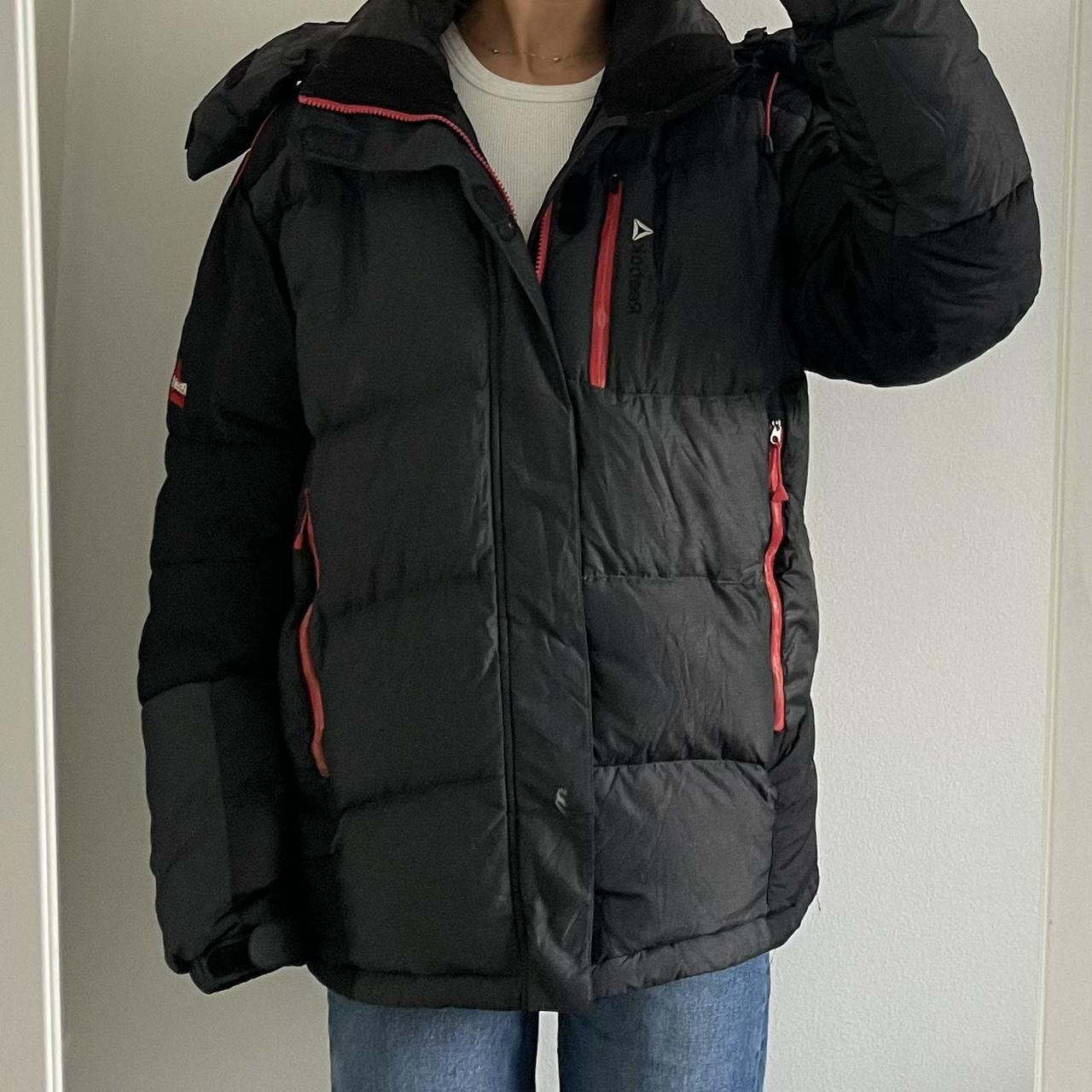 Grey and black reebok puffer jacket, no size on... - Depop