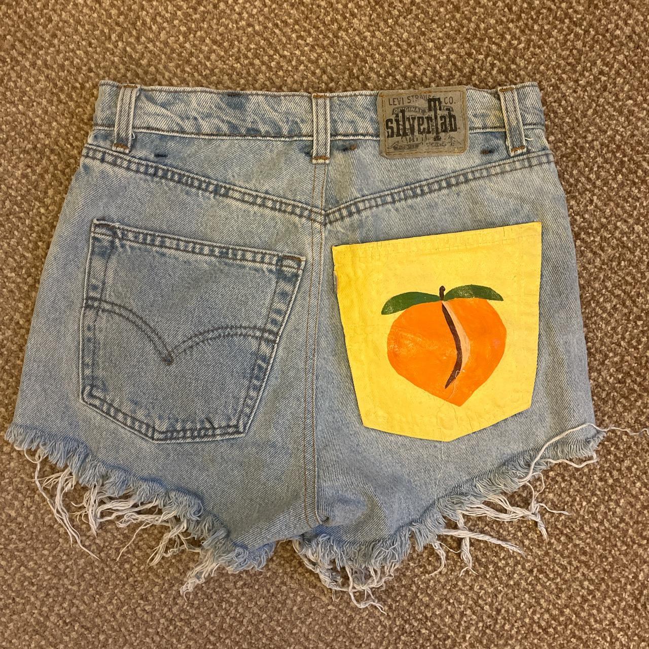 Size 26 waist Levi’s Jean shorts with a peach on the... - Depop