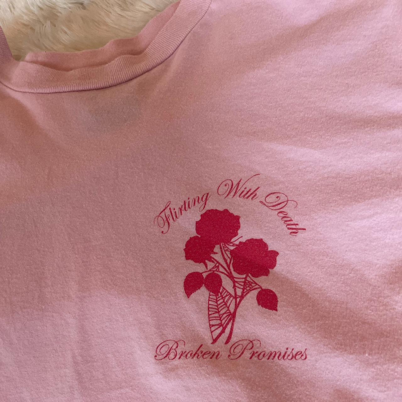 Cropped pink broken promises shirt. Tiny hole as... - Depop